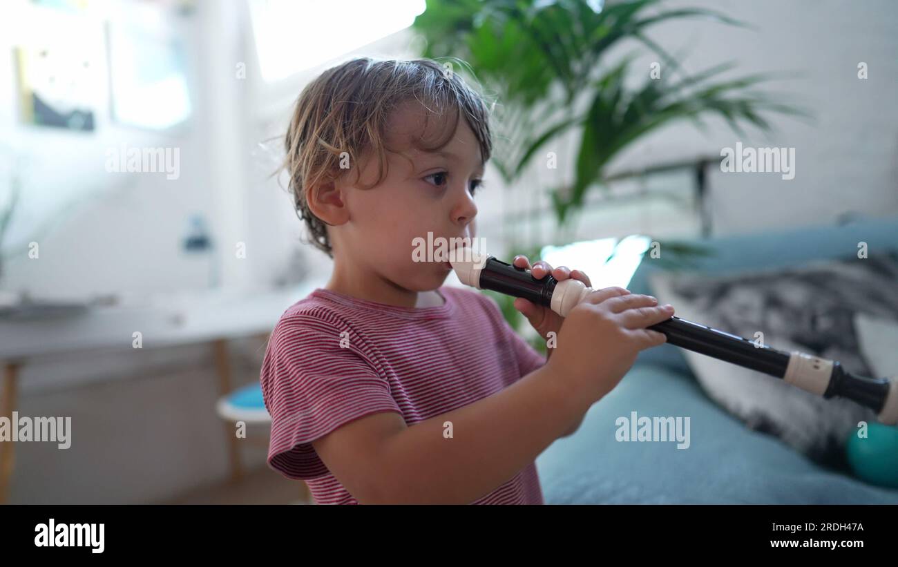 Two little boys playing flute musical tune together Stock Photo - Alamy