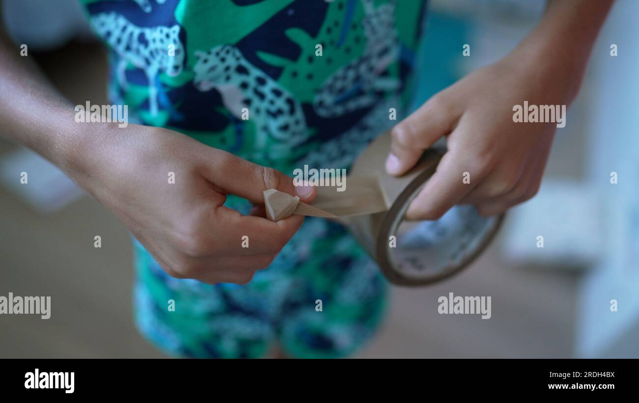 Hand tearing duct tape tool Stock Photo - Alamy