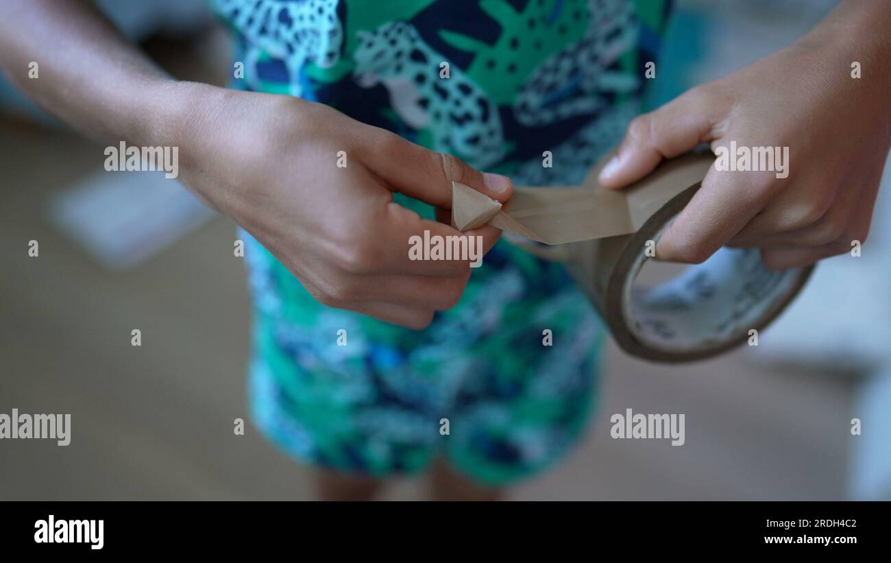 Hand tearing duct tape tool Stock Photo - Alamy