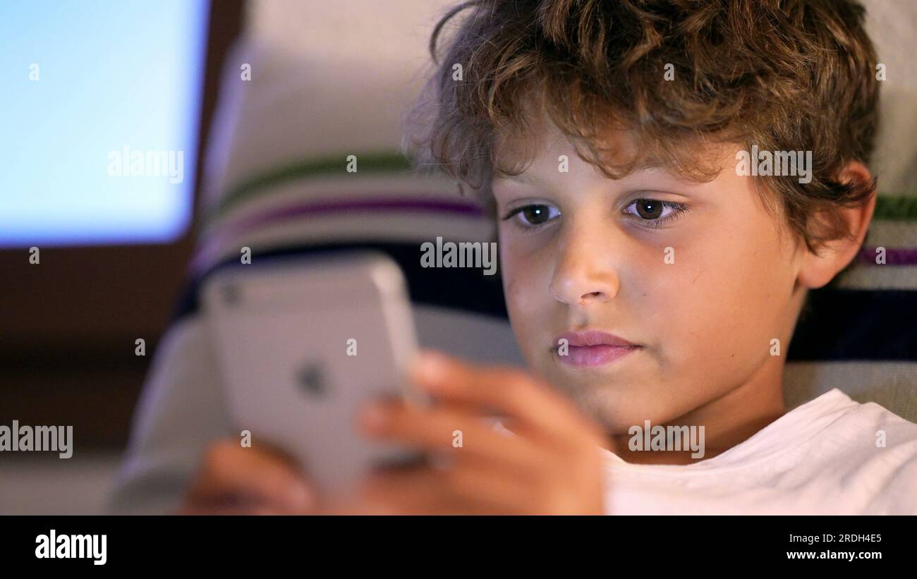 One addicted teenager boy staring at smartphone screen Stock Photo - Alamy