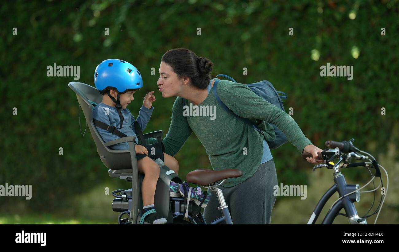 Mother and child loving moment together riding bicycle kid sitting on ...