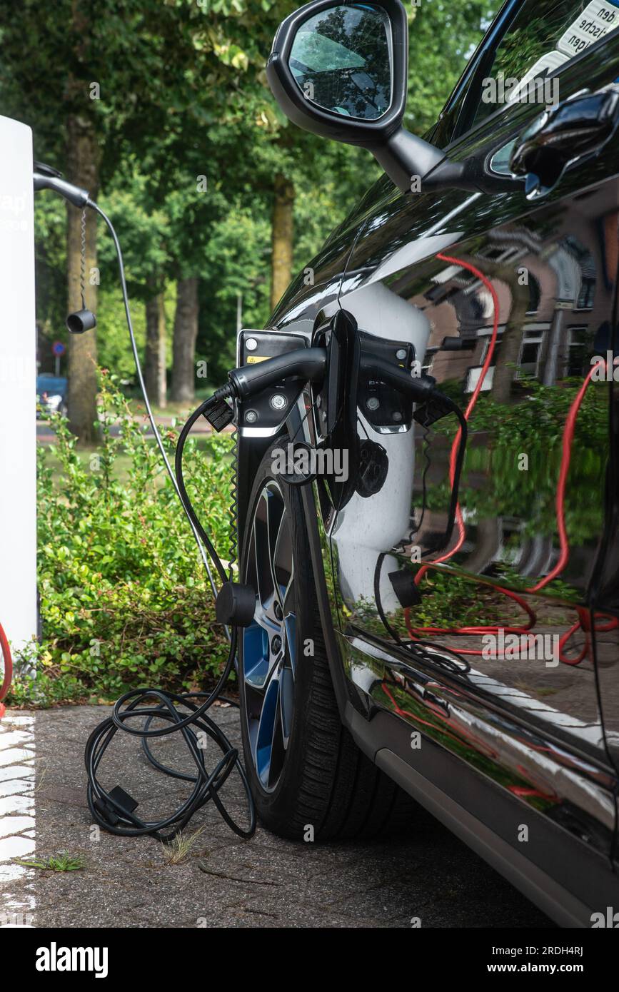 Raalte, the Netherlands - July 21st 2023: Electric SUV charging at a ...