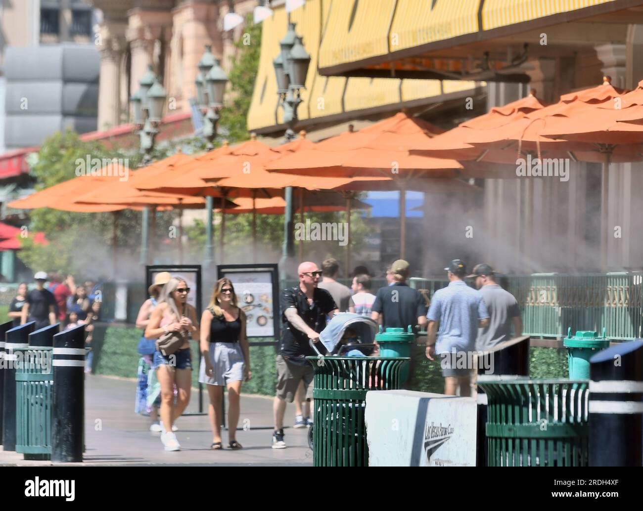 Las Vegas, USA. 20th July, 2023. Tourists stop at a series of misters ...