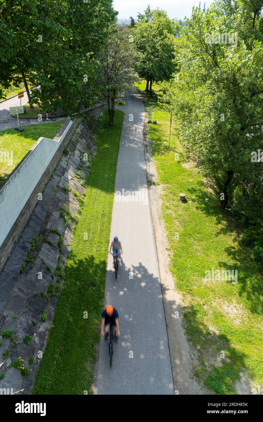 Villach, Austria. July 18 2023. cyclists on a cycle path that runs ...