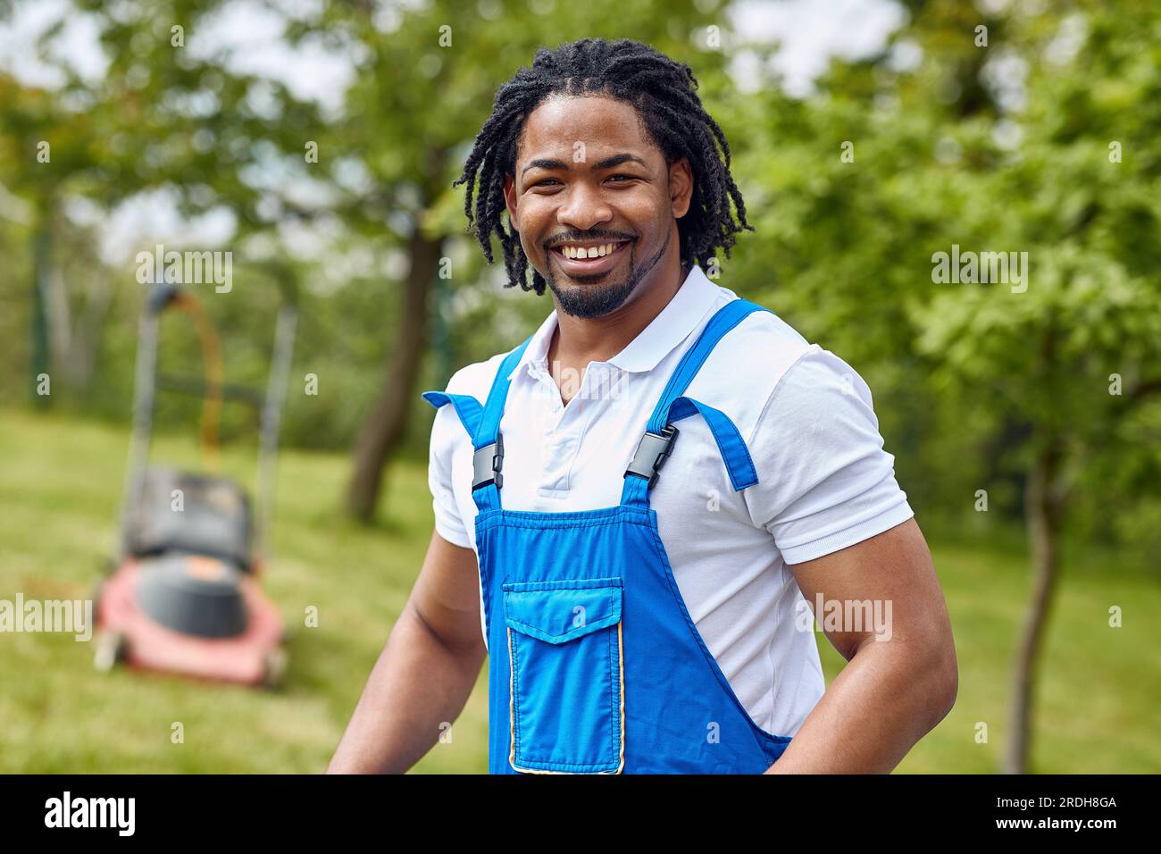 Afro-American groundskeeper in a close-up shot, wearing a uniform and a ...