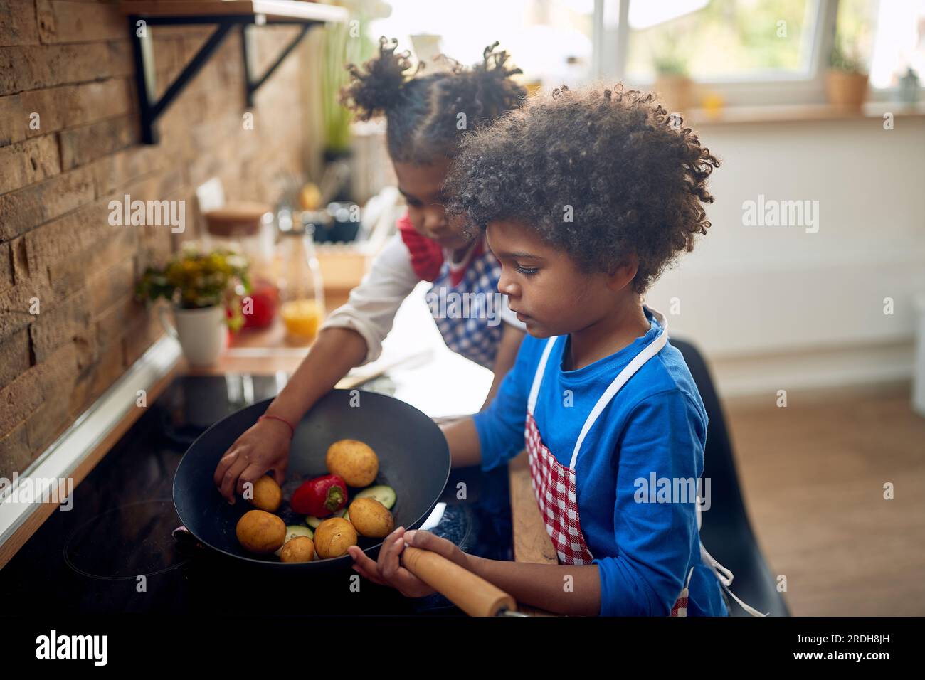 Black boy cooking in the kitchen hi-res stock photography and images ...