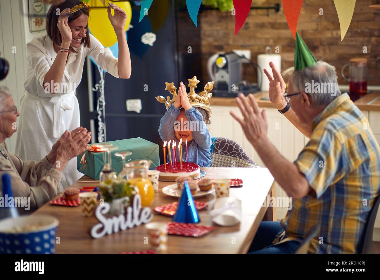 Cheerful happy family celebrating birthday together clapping and ...