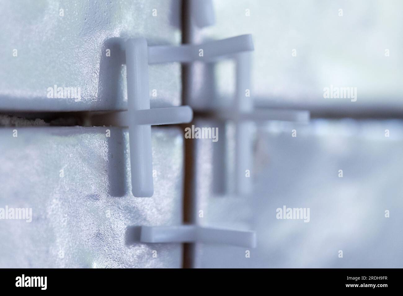 A close up portrait of plastic white joint spacers placed in the ...