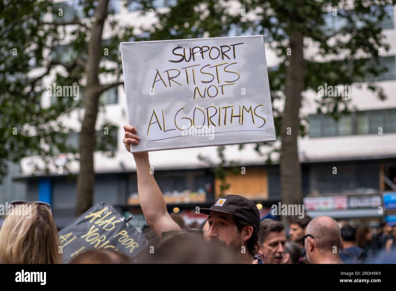 A protester holds placard against use of AI, Actors Union Equity rally ...