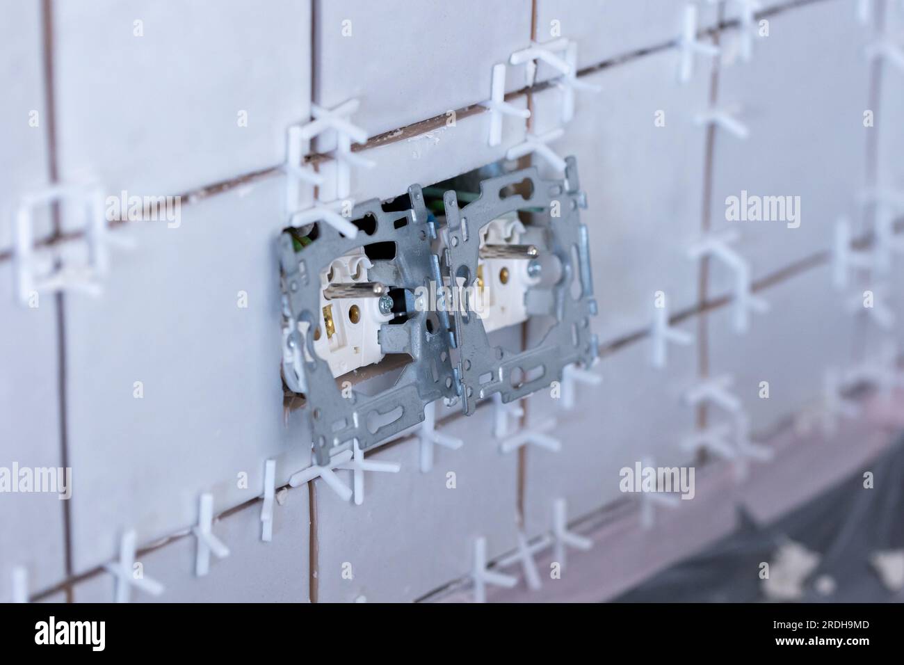 A close up portrait of two connected electric wall sockets without ...