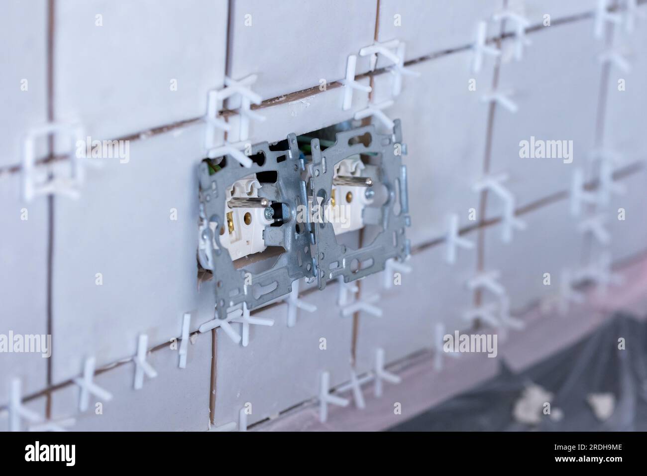 A close up portrait of two connected electric wall sockets without ...