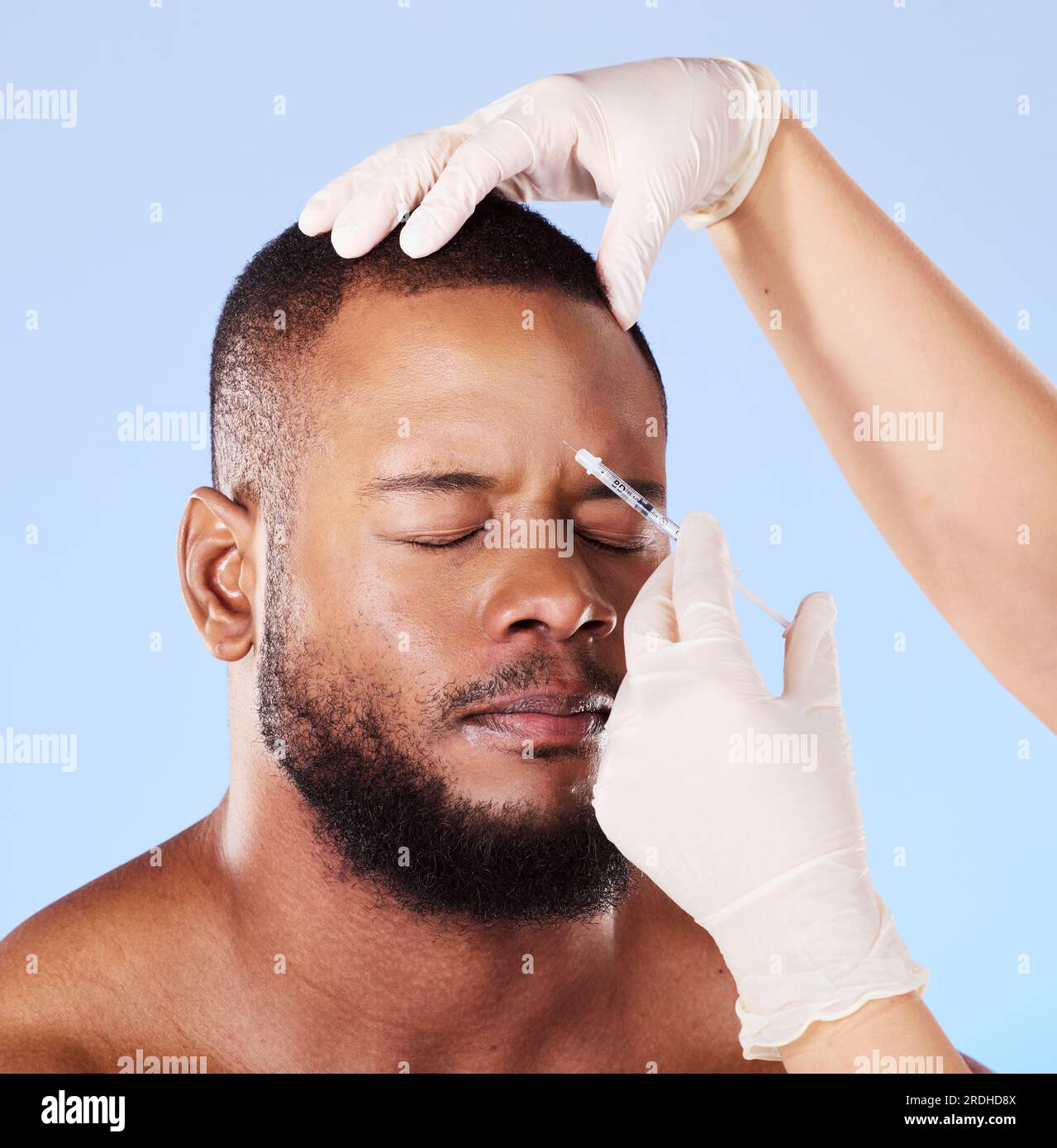Black man, plastic surgery and syringe in studio for beauty, anti-aging ...
