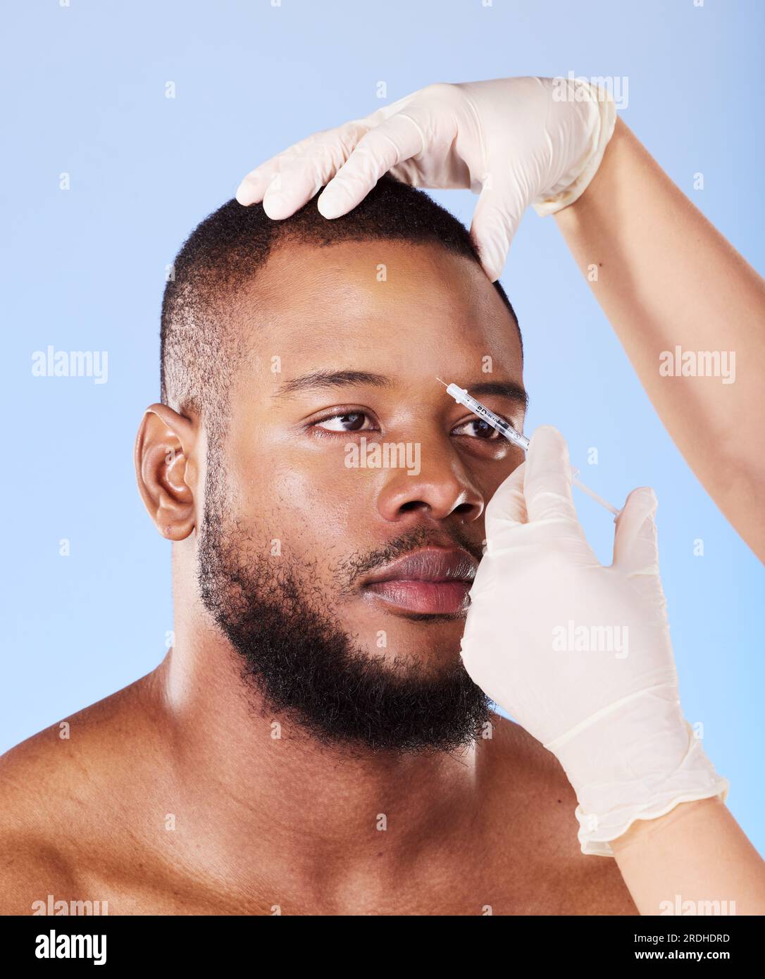 Black man, plastic surgery and needle in studio for beauty, dermatology ...