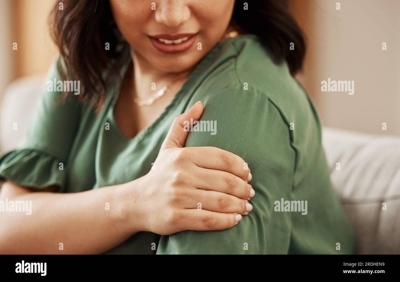 Hands, shoulder pain and woman on sofa, massage or stress injury for ...