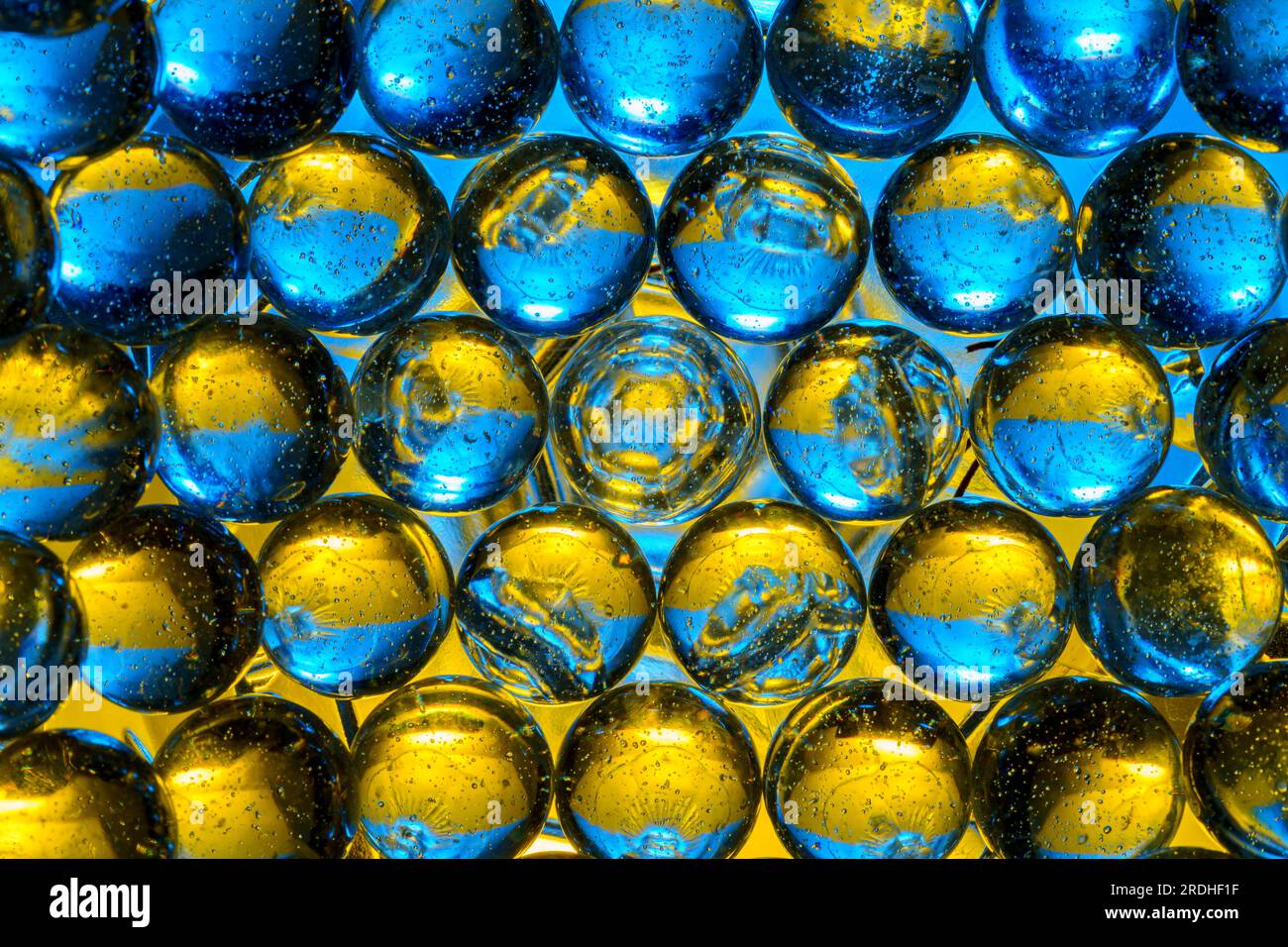 Blue over gold, back lit clear marbles, reminiscent of the Ukraine flag ...