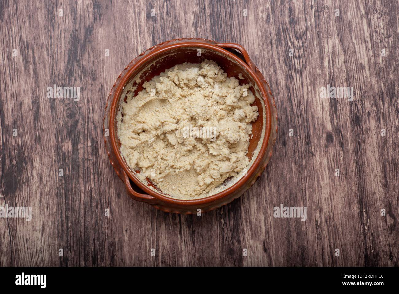 Clay pot with nixtamalized corn dough to make tortillas. Dough to ...