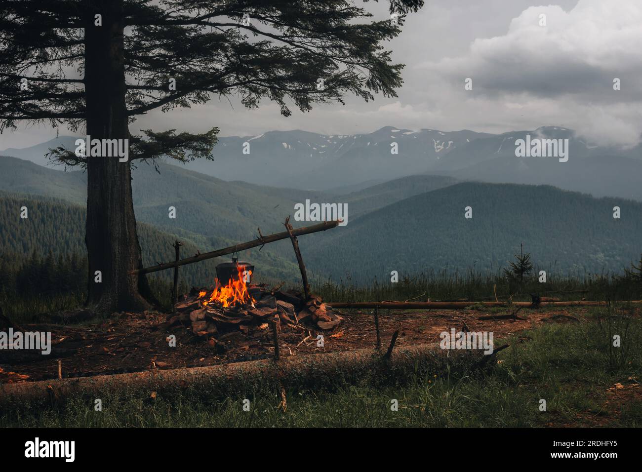 Cooking food on campfire in mountains. Camping season, Cauldron on the ...
