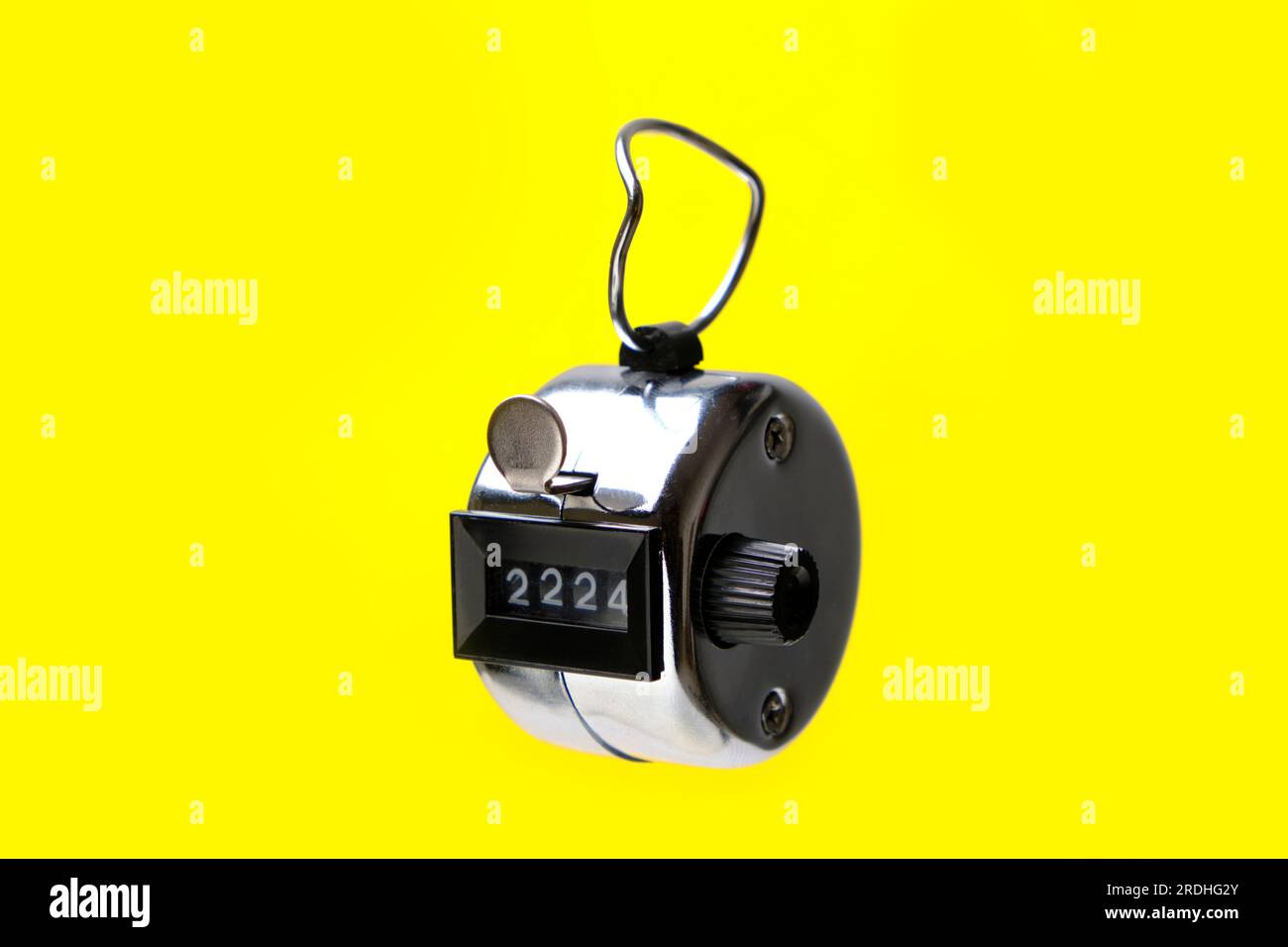 Manual mechanical counting counter on yellow background Stock Photo - Alamy