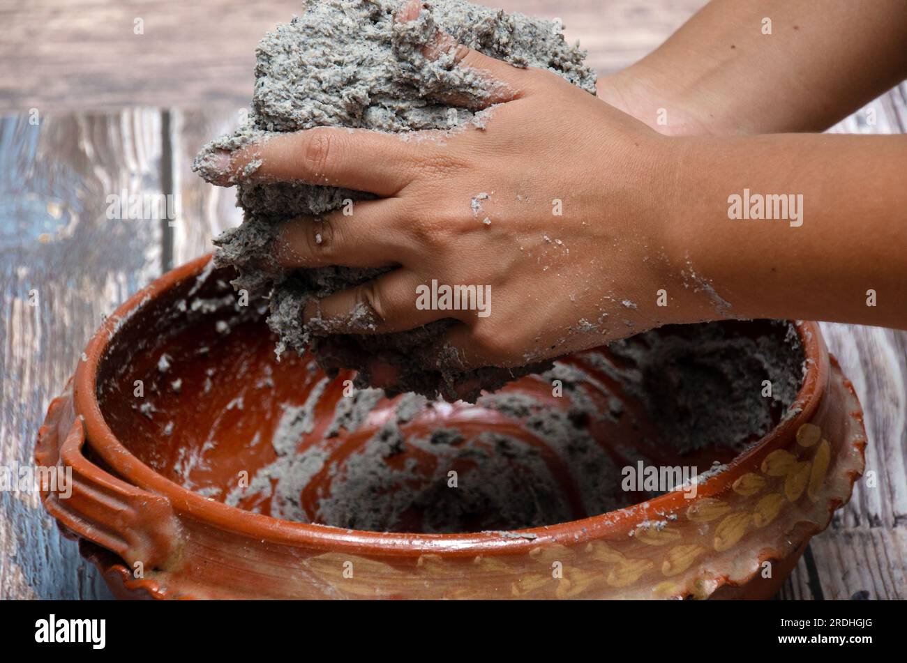 Woman's hands mixing corn dough to make tortillas. Mexican basic food ...