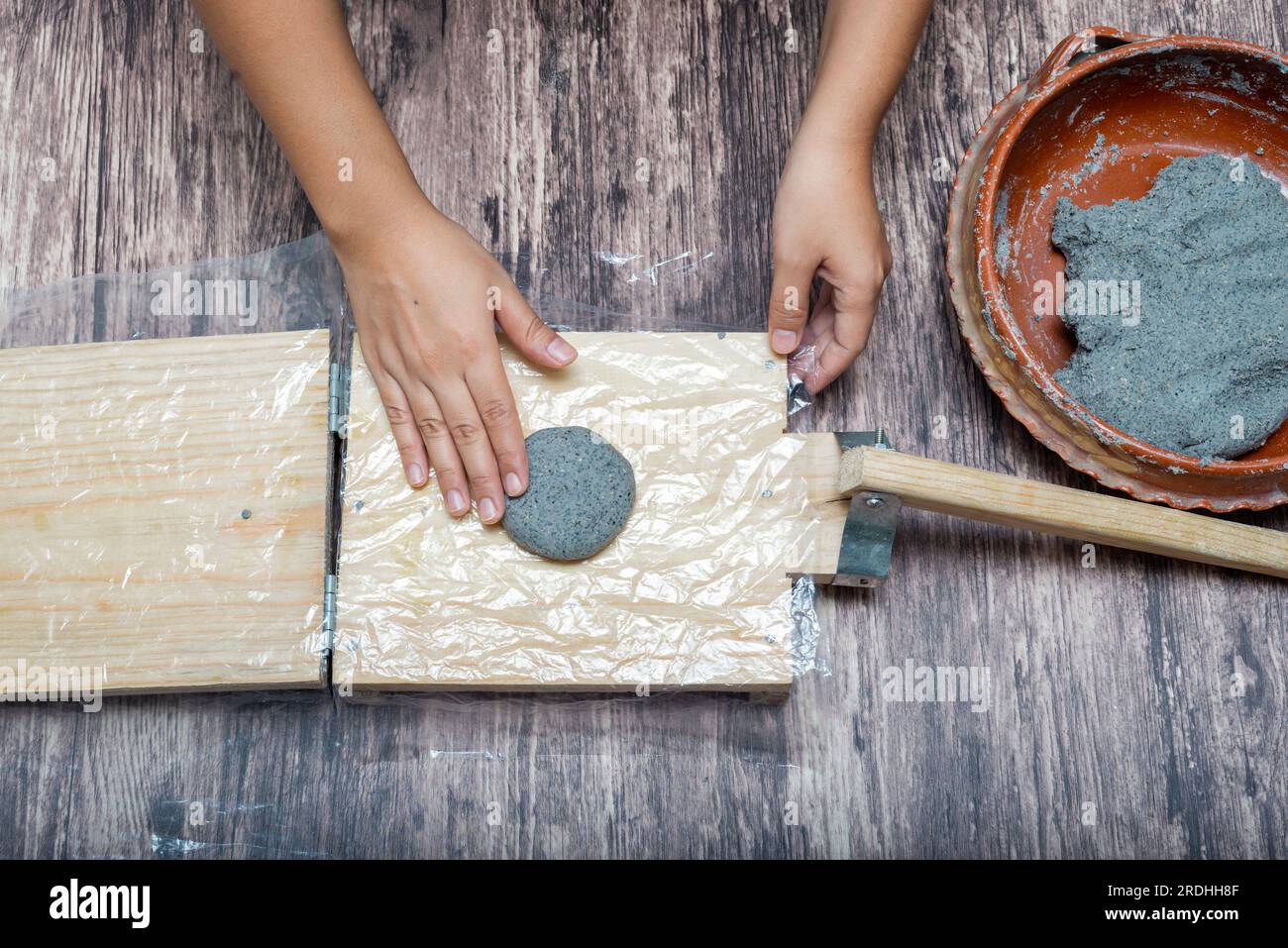 Person making corn tortillas at home with a hand tortilla maker Stock ...
