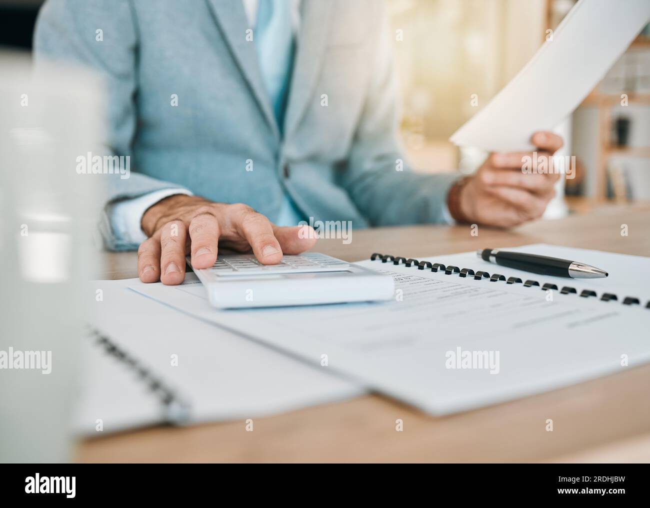 Accounting paperwork, hands and calculator for an audit, finance ...