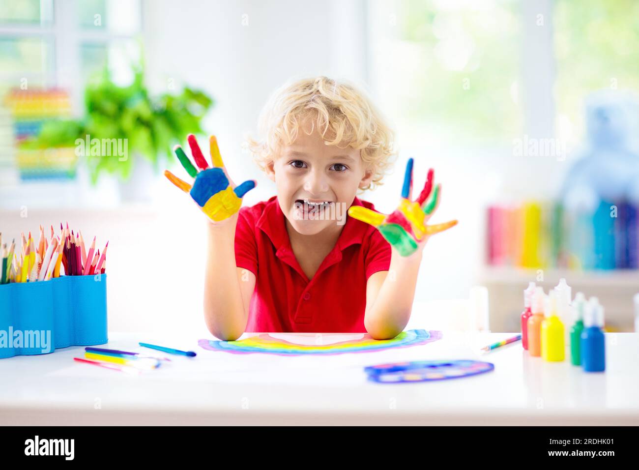 Kids paint. Child painting in white sunny study room. Little boy ...