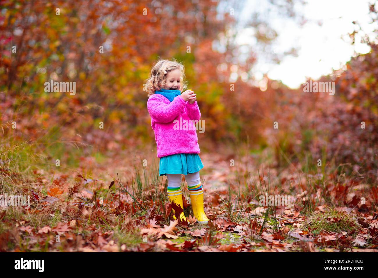 Kids play in autumn park. Family fun in fall season. Little girl ...