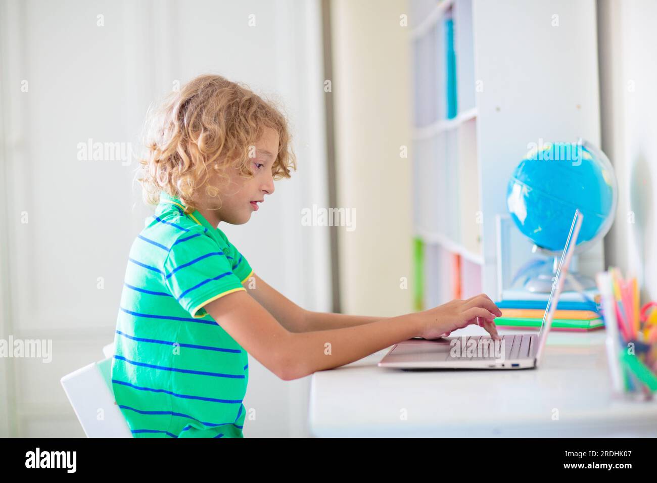 Child doing homework on computer. Online class. Homeschooling and ...