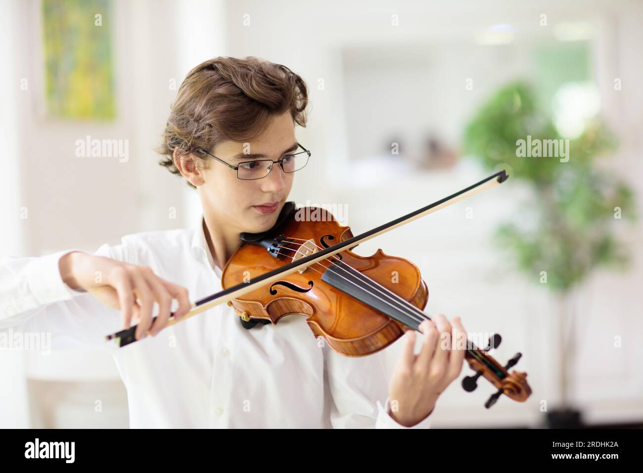 Man playing violin. Classical music instrument. Teenage boy practicing ...