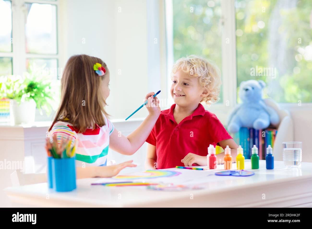 Kids paint. Child painting in white sunny study room. Little boy and ...
