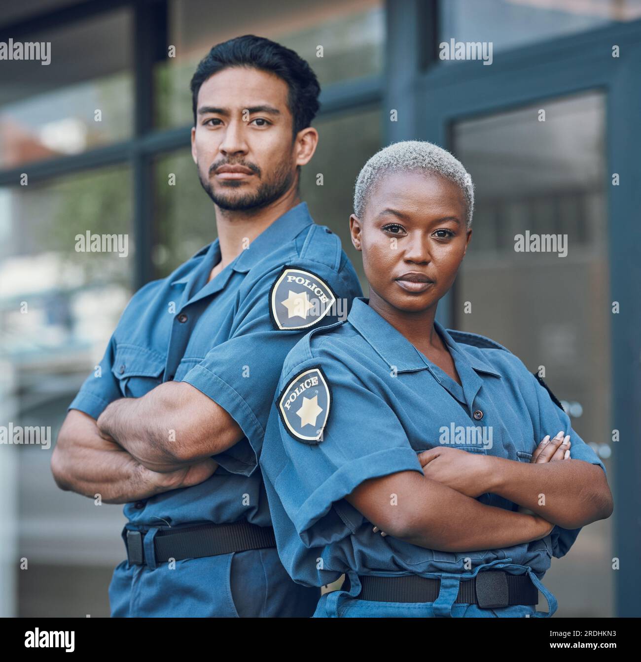 Portrait, serious and arms crossed with the police force standing ...
