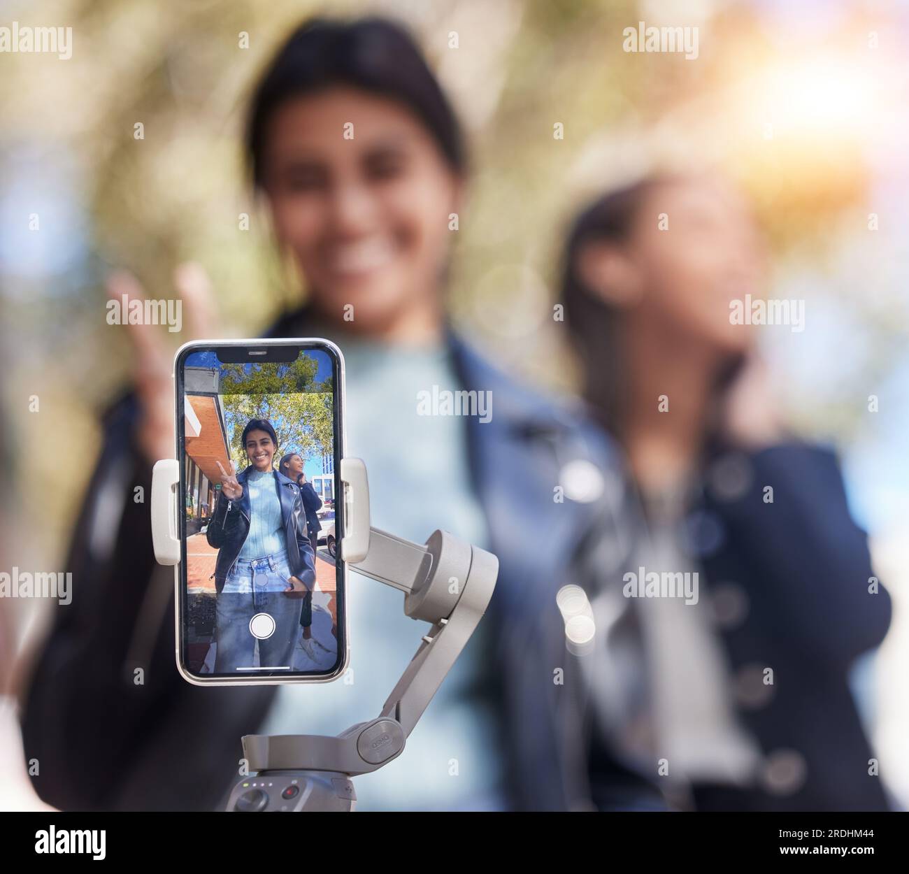Portrait, friends and phone selfie with peace sign in city, smile and ...