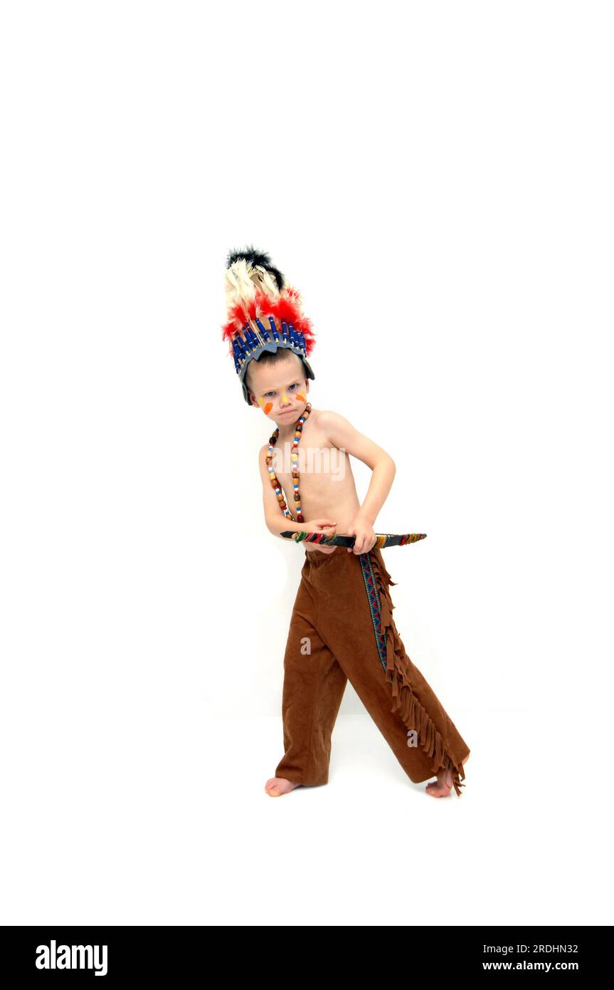 Cute little boy dresses up to play indian chief. He is wearing a ...