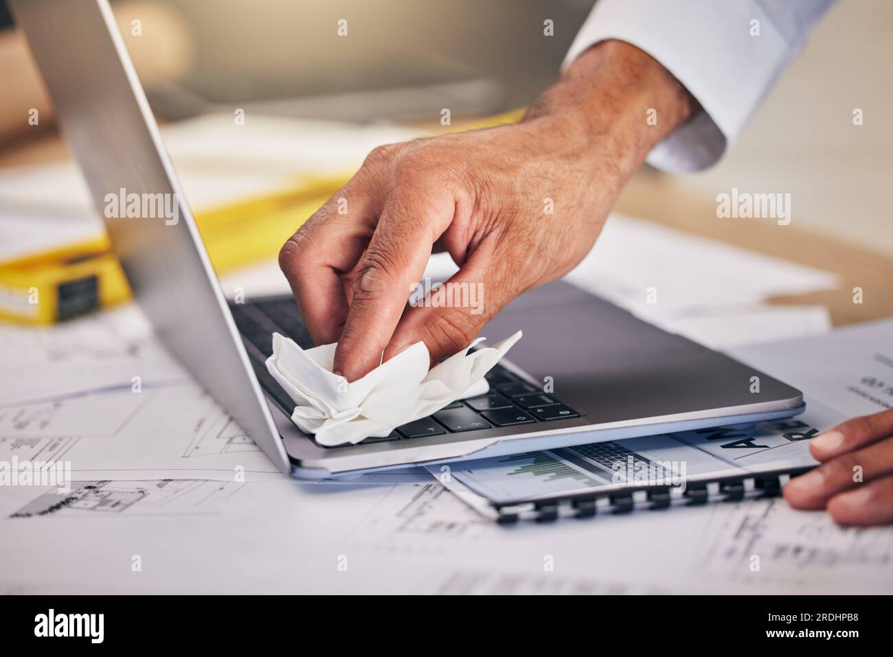 Hand with cloth, keyboard on laptop and cleaning dust or dirt from ...