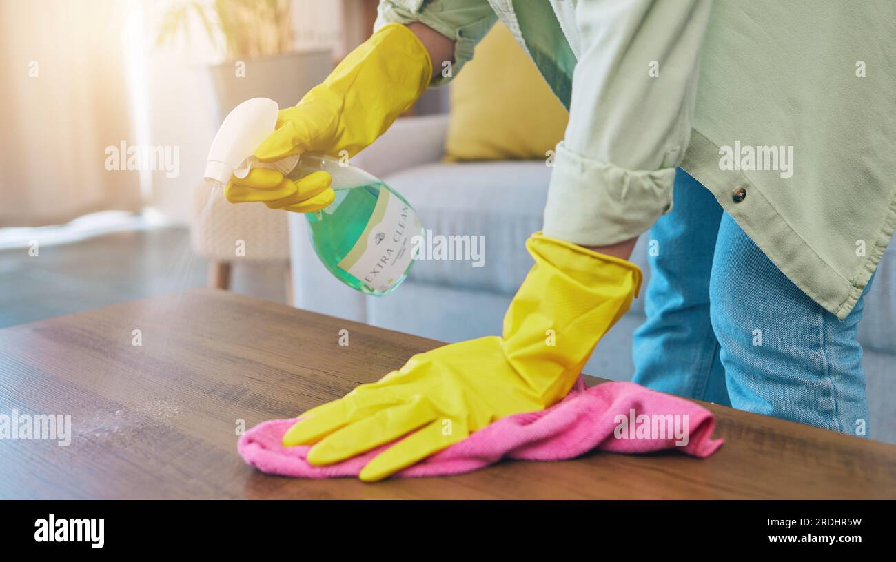Woman, hands and cleaning table with spray for housekeeping, hygiene or ...