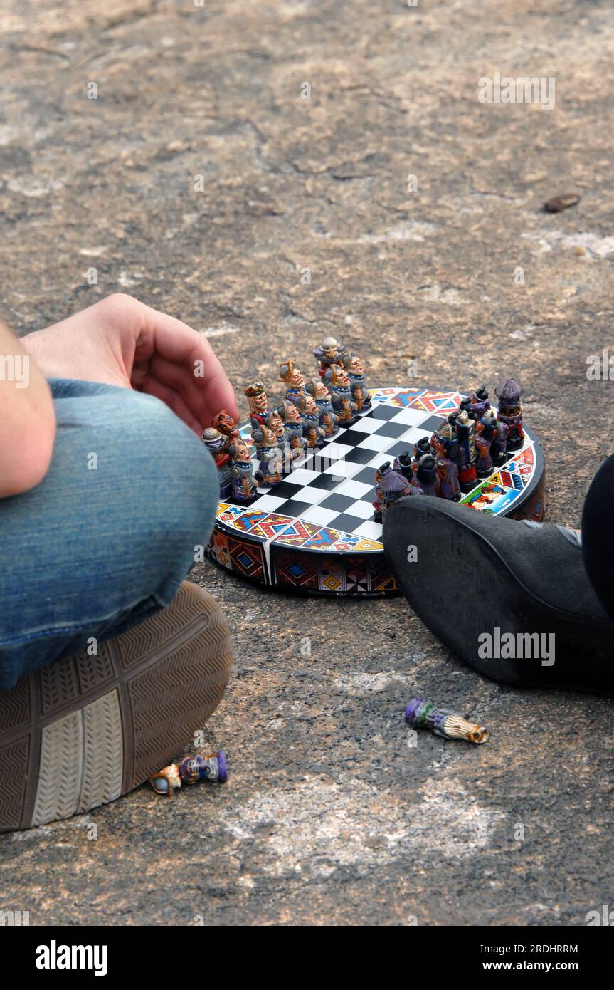 Two young college students play a game of chest with an unusual round ...