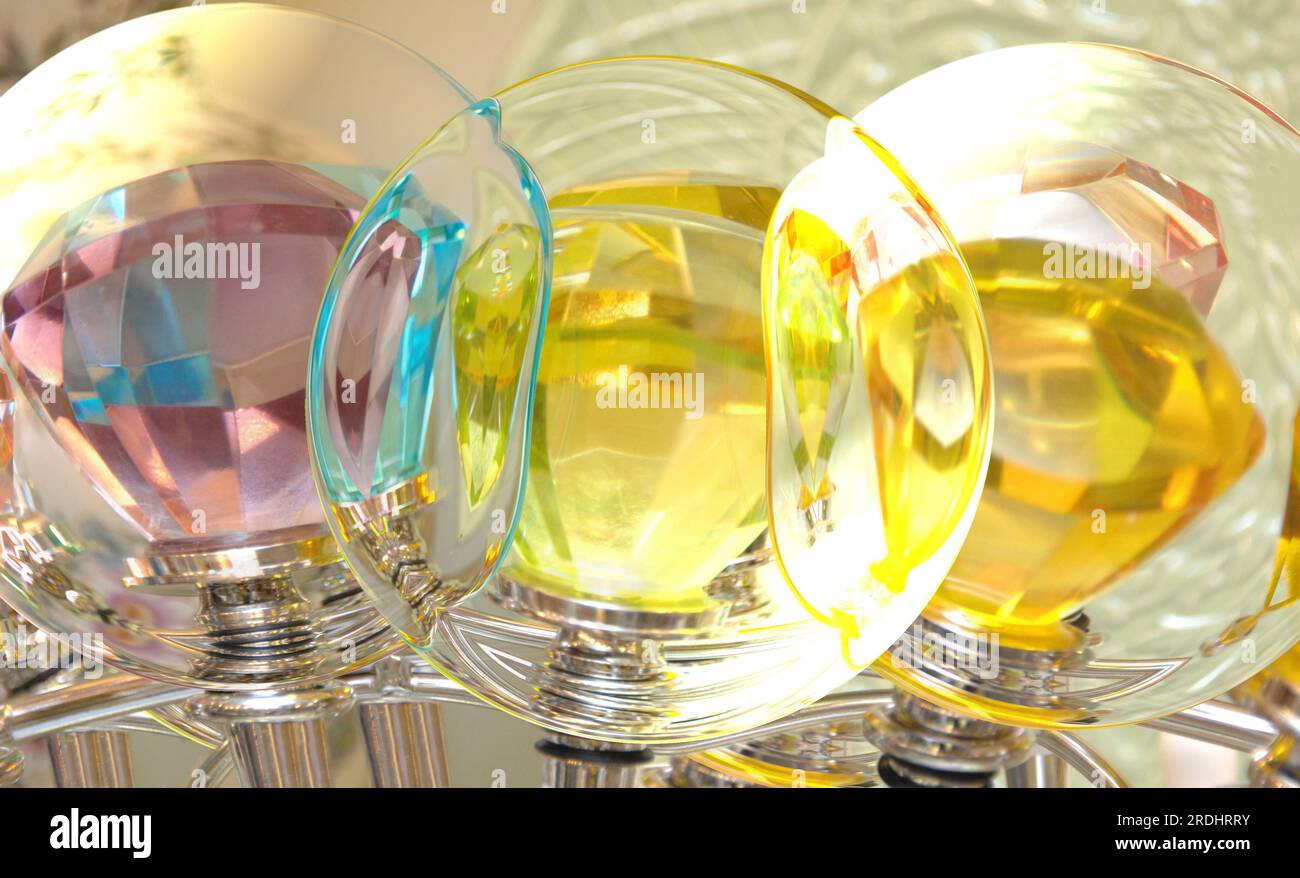 Large pink, blue and yellow diamonds are encased in transparent bubble ...