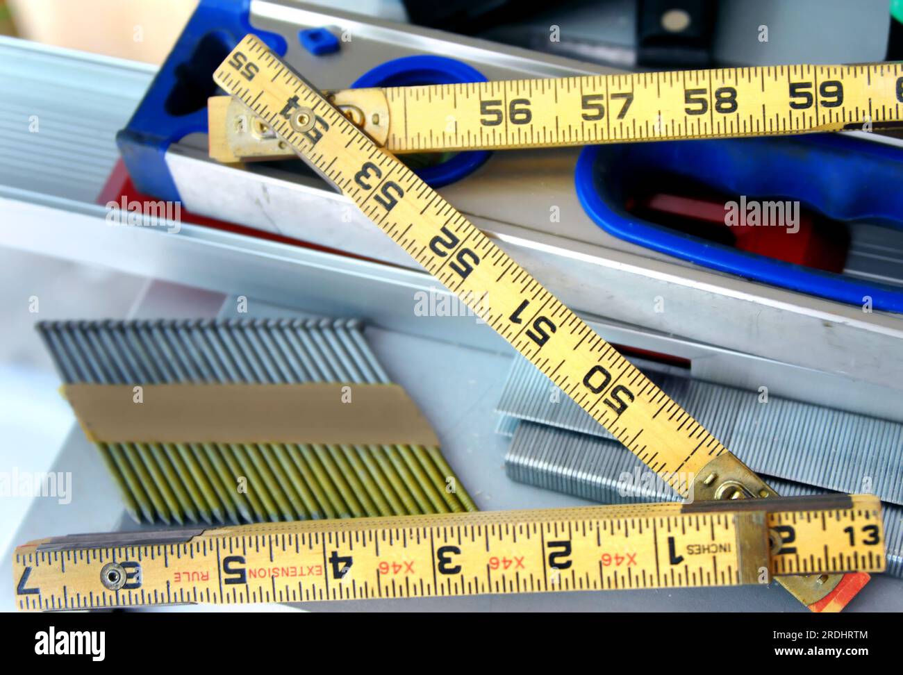 Yellow extension ruler is opened forming the letter "Z". Rule lays on ...