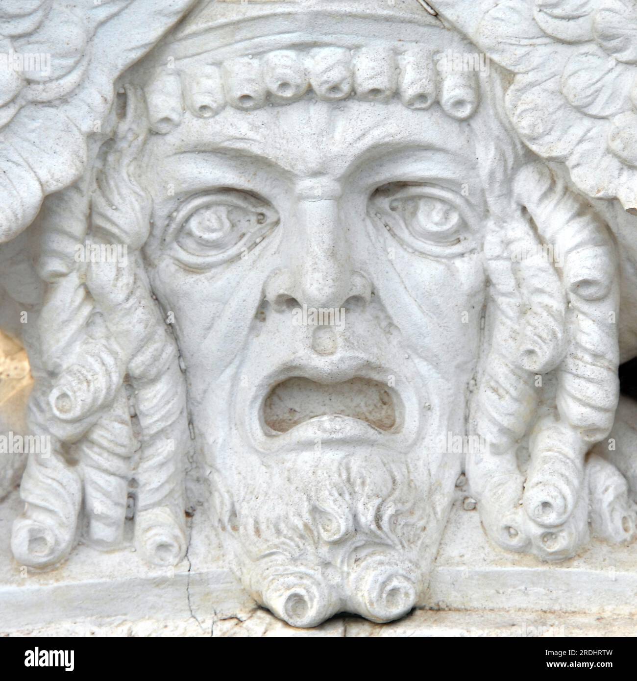 Satue face reflects an agony of pain or defeat. Mouth hangs open with ...