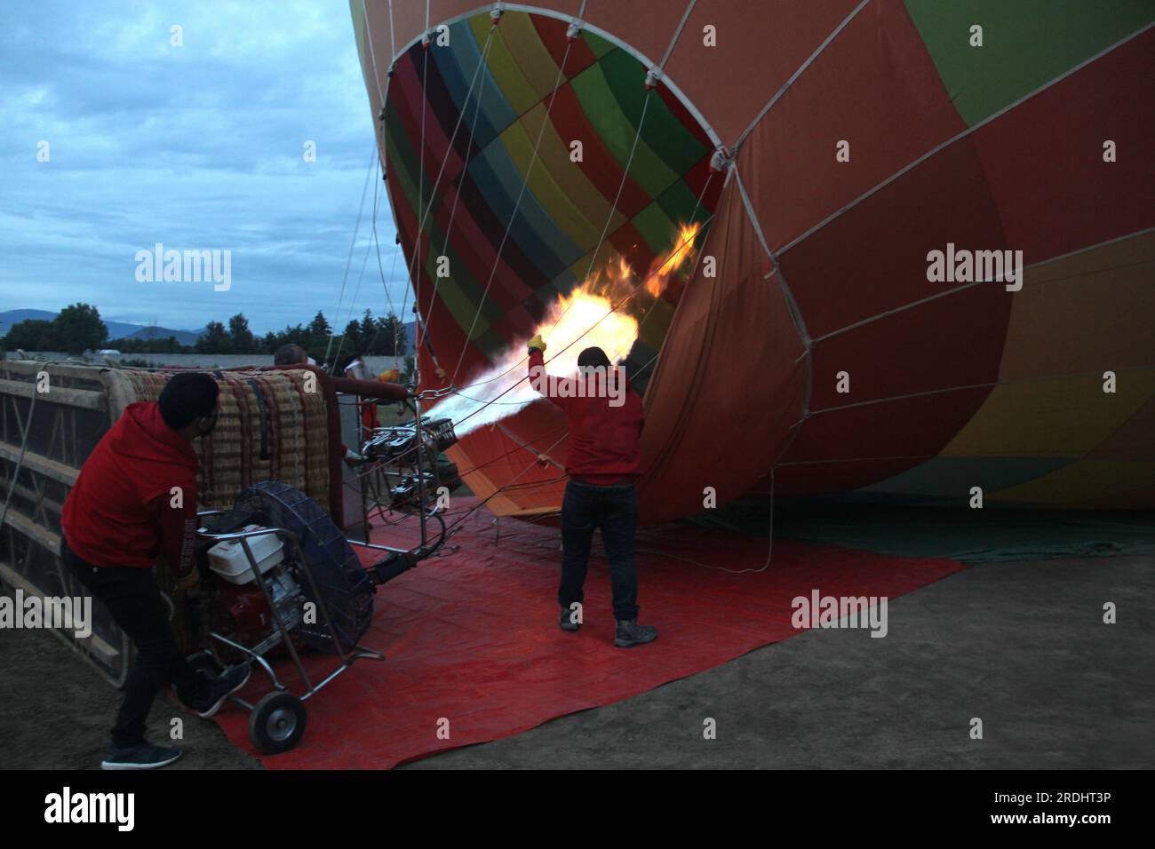 Process of inflation and preparation of hot air balloon at sunrise for ...
