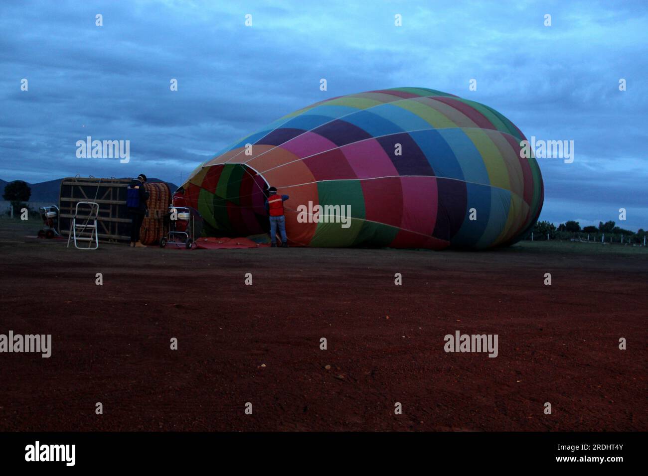 Process of inflation and preparation of hot air balloon at sunrise for ...