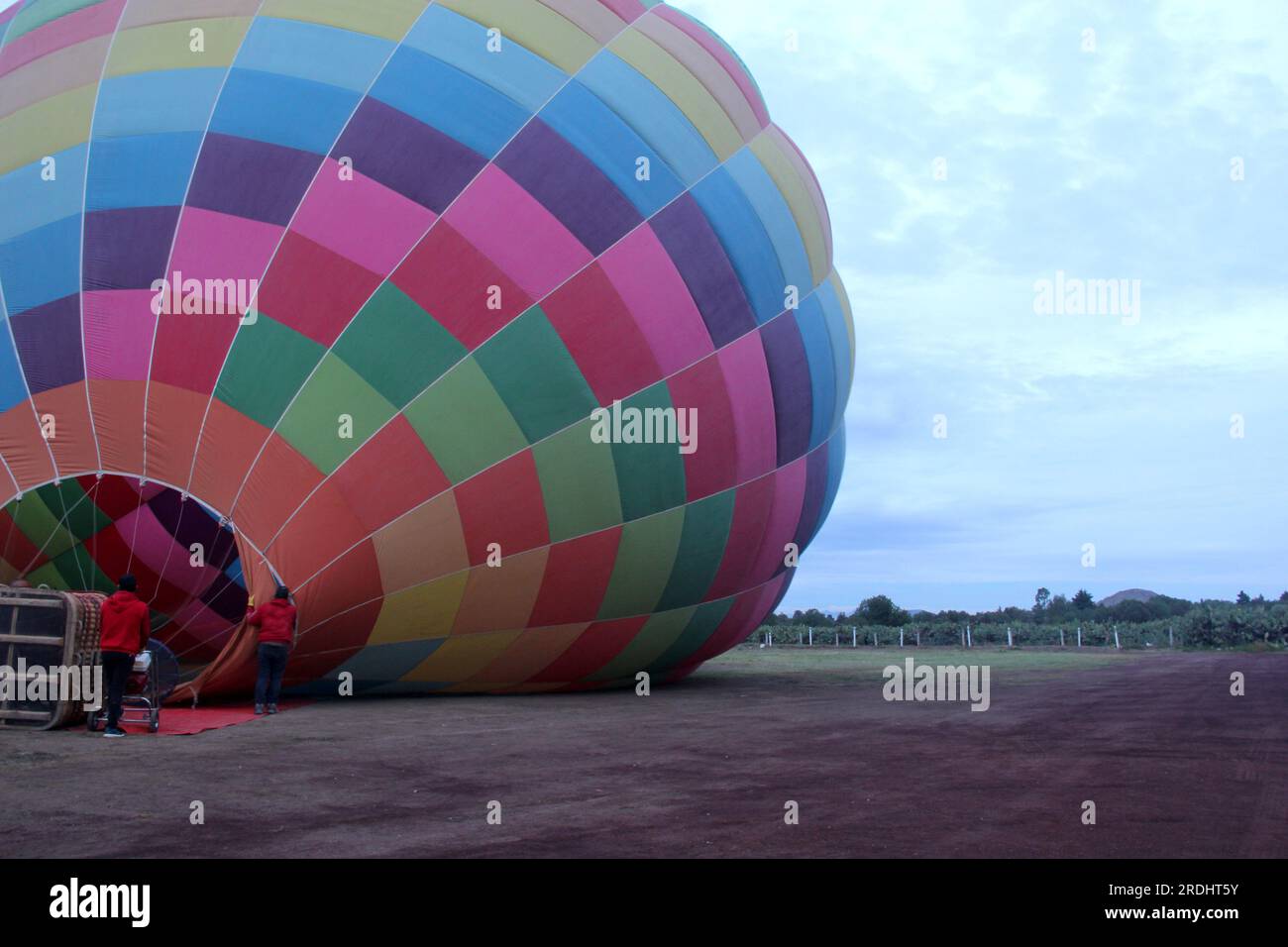 Process of inflation and preparation of hot air balloon at sunrise for ...