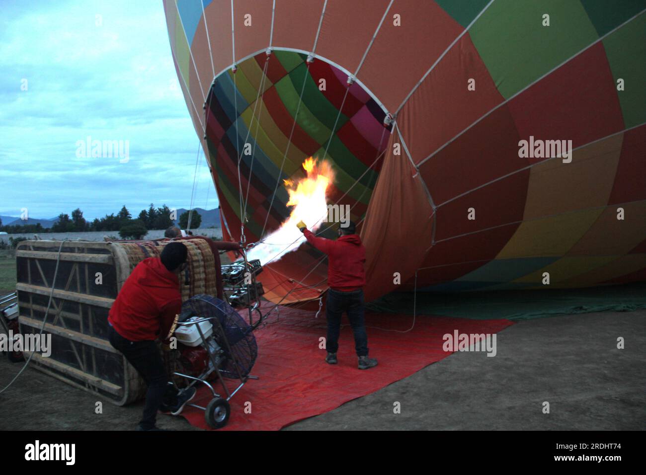 Process of inflation and preparation of hot air balloon at sunrise for ...
