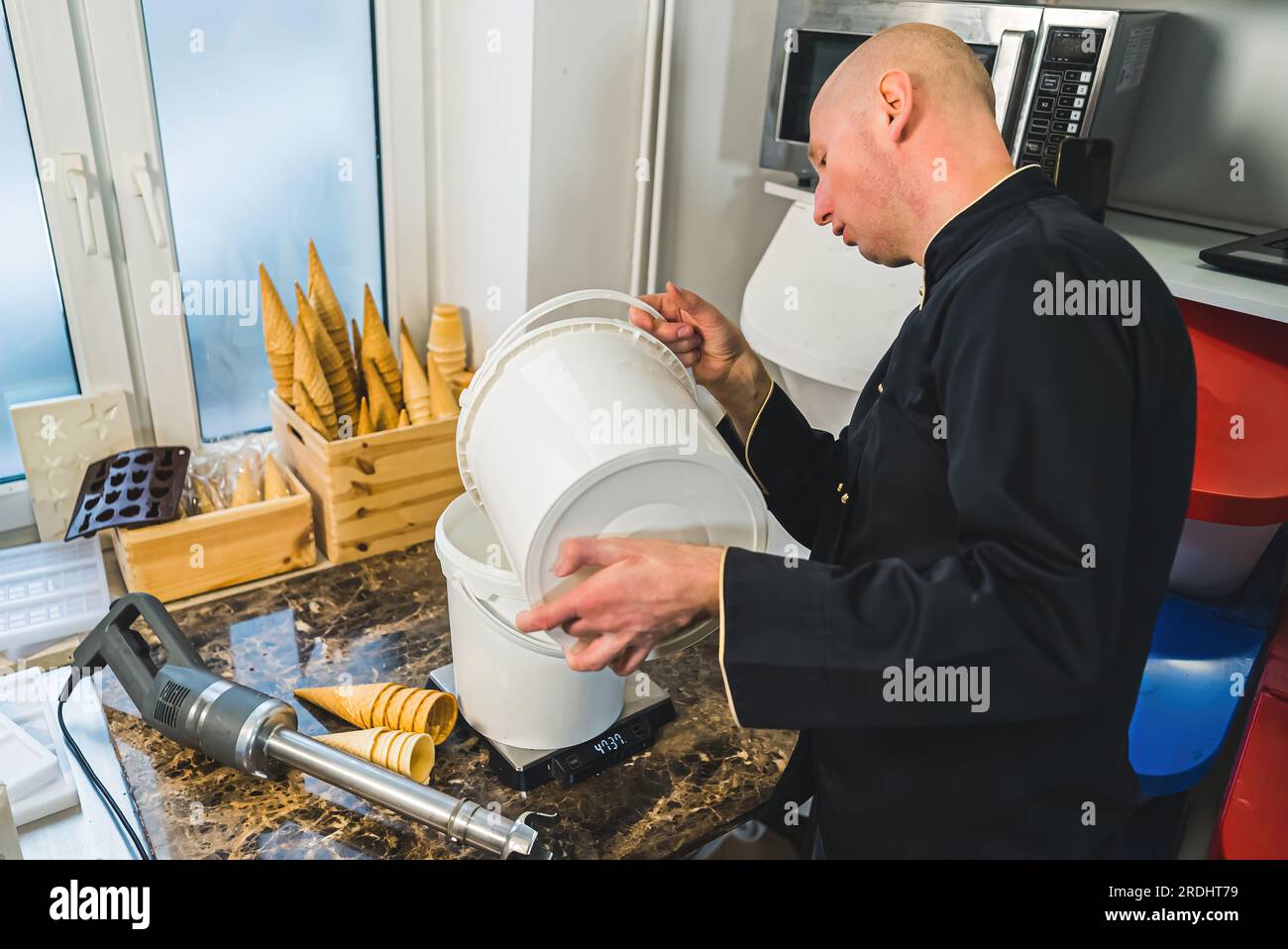 Chef making ice cream. Professional process of producing delicious ice ...