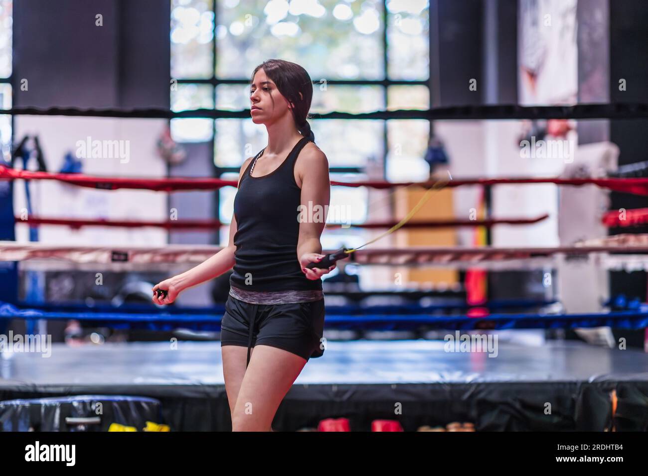 Jumping rope warm up. Sportswoman fitness training working out in ...