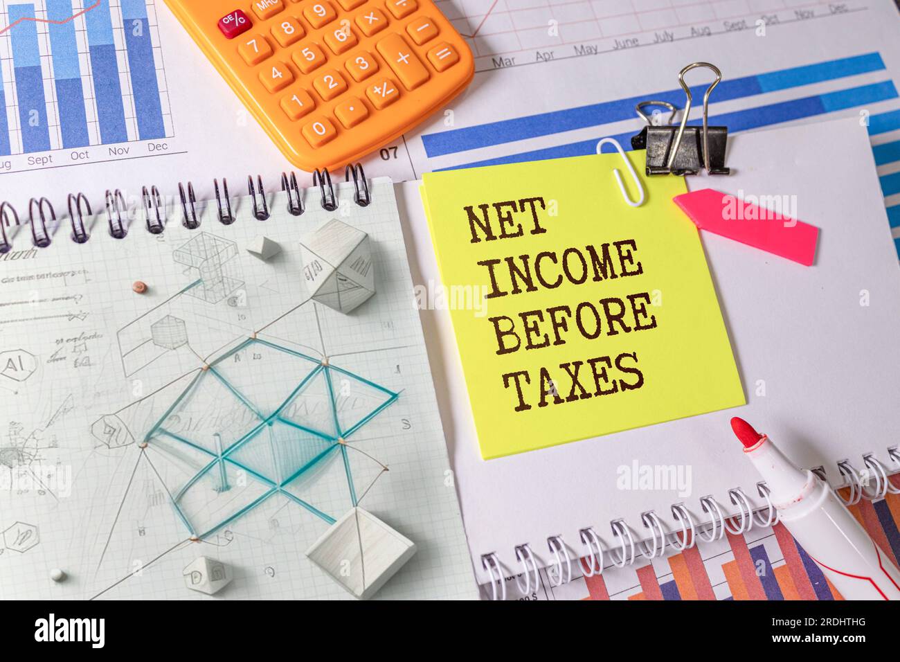 Net Income Before Taxes, text on white paper on torn paper background ...