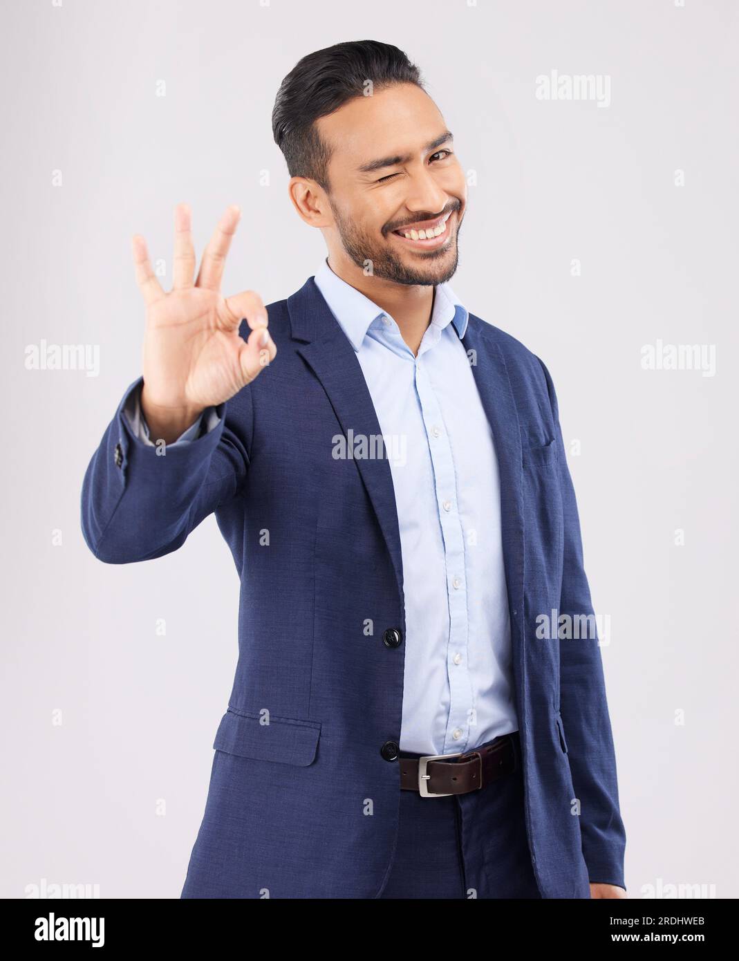 Wink, portrait and asian man with perfect hand sign for support ...