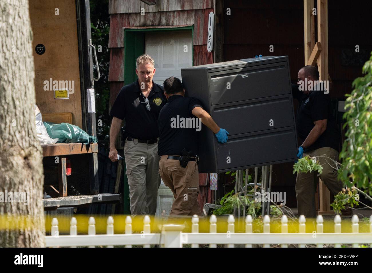 FILE - New York State police officers move a metal cabinet as law ...
