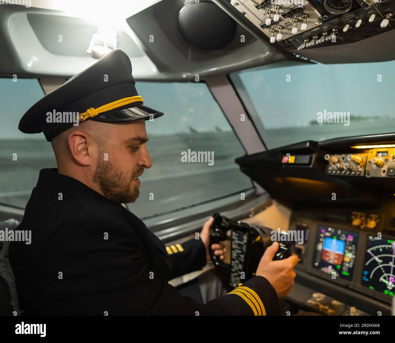 Caucasian bearded man smiling while sitting in a flight simulator ...
