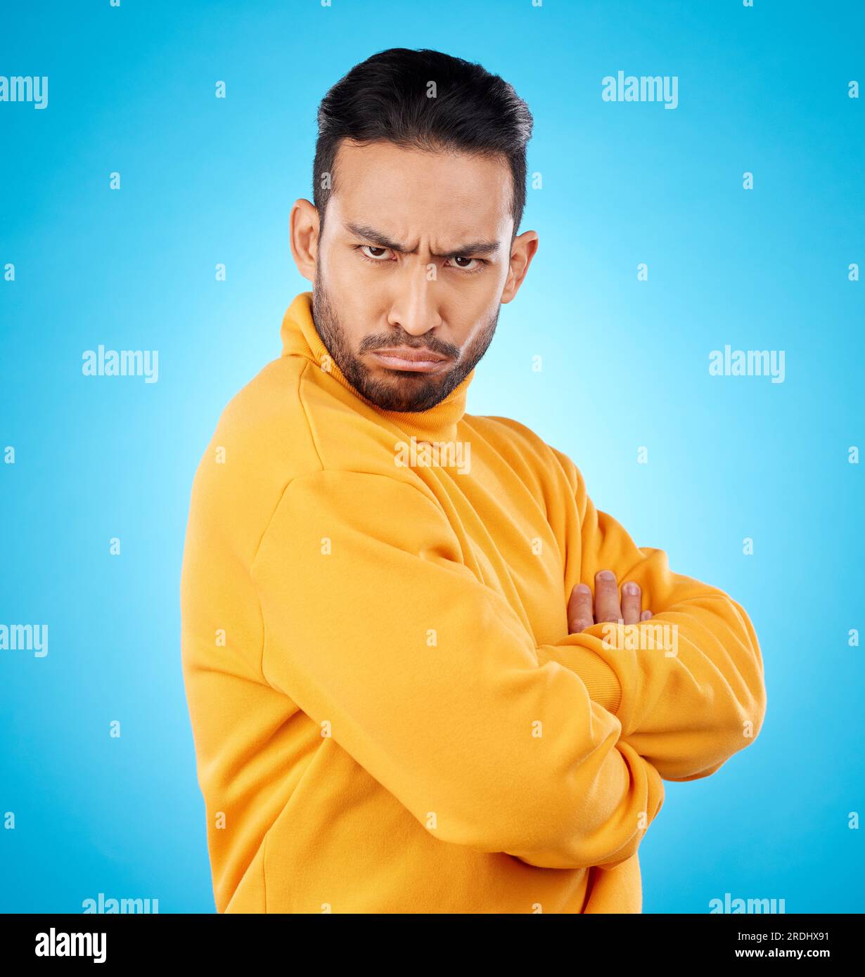 Portrait, frown and asian man with arms crossed in studio angry ...